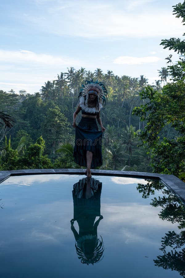 Model Dressed in American Indian Posing on an Edge of Infinity Pool in ...