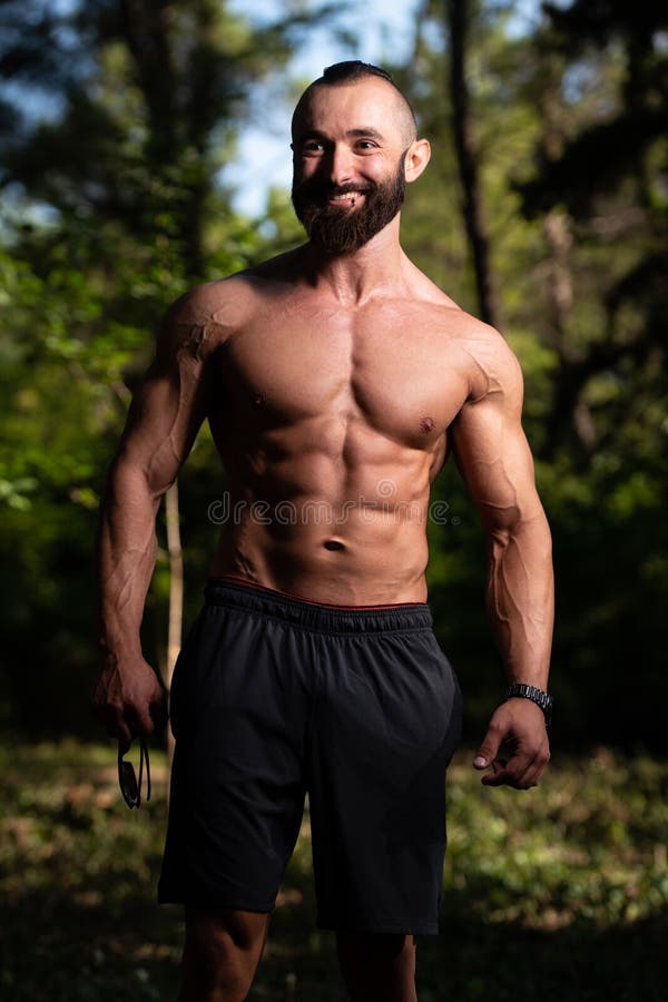 Model Flexing Muscles Outdoors Stock Photo - Image of muscle, handsome ...