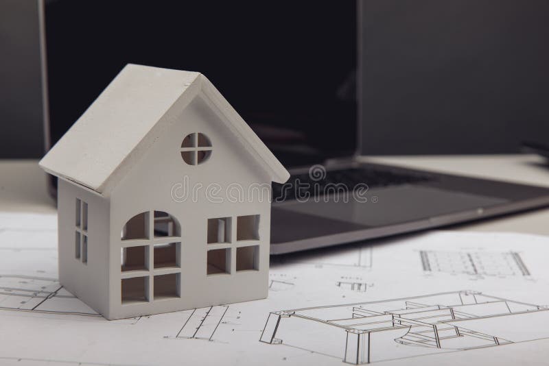 Model of House and Laptop on Drawing. Building and Architect Concept ...