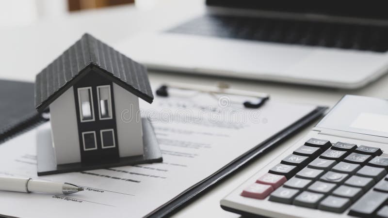 Model House Put on Contract Documents with Calculator and Laptop ...