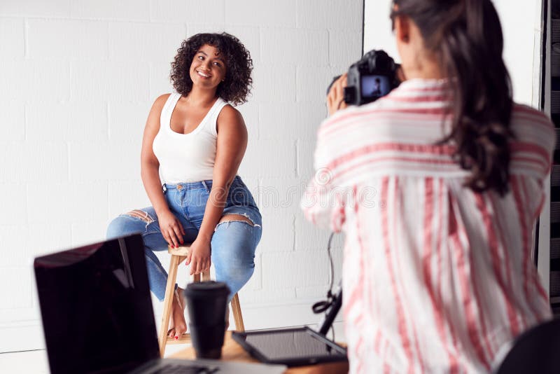 Model Posing for Female Photographer in Studio Portrait Session Stock ...