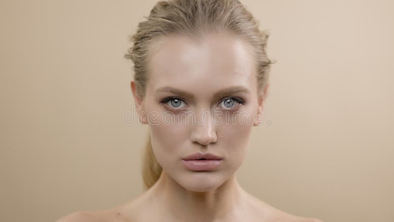 Model Posing in Front of the Camera. Face of Blonde Girl with Serious ...