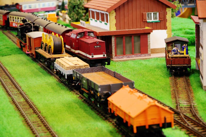 Small Train Station on a Model Railway Layout with a Train Passing ...