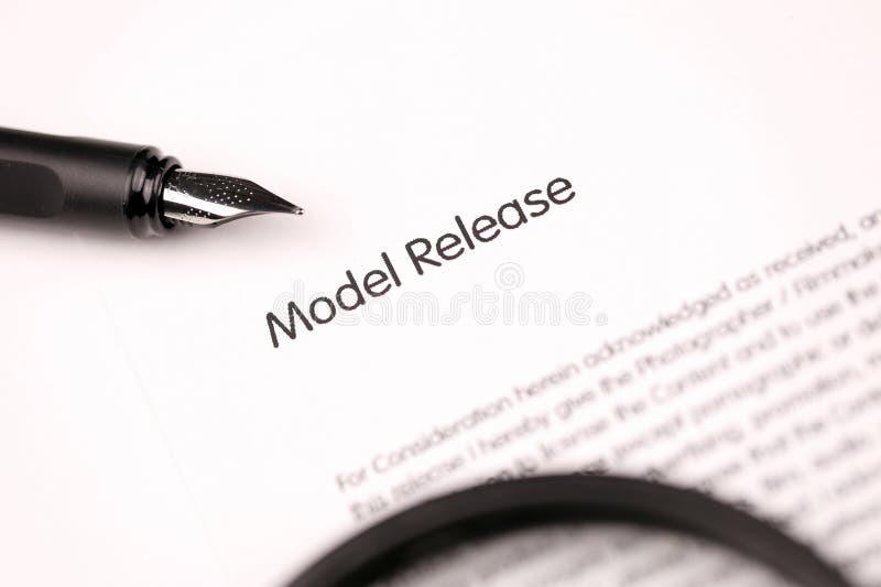 Model Release on A4 Tablet Lies on Office Table with Pen and Magnifying ...