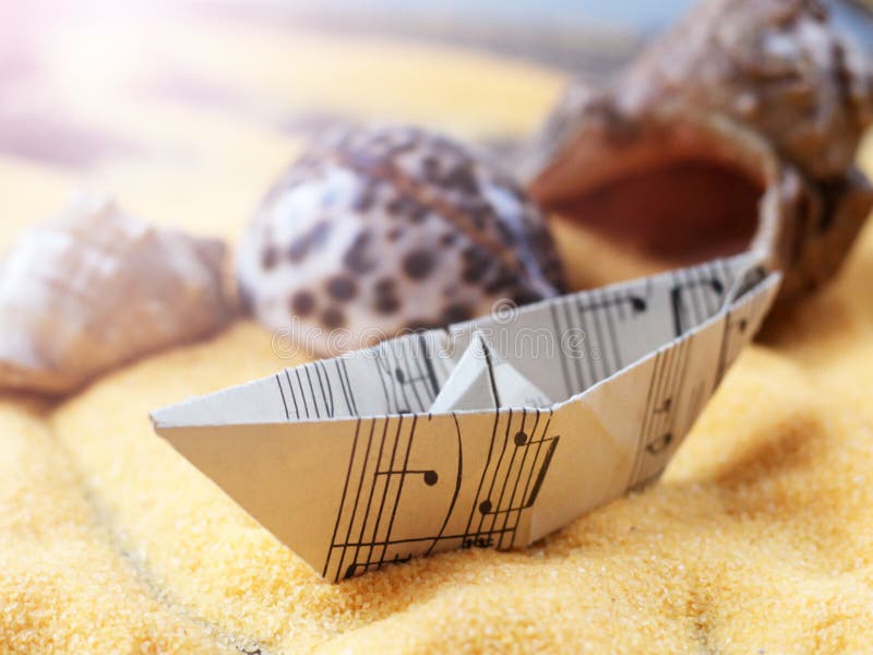 Model of a Ship Made of Paper Musical Notes on the Sand Stock Photo ...