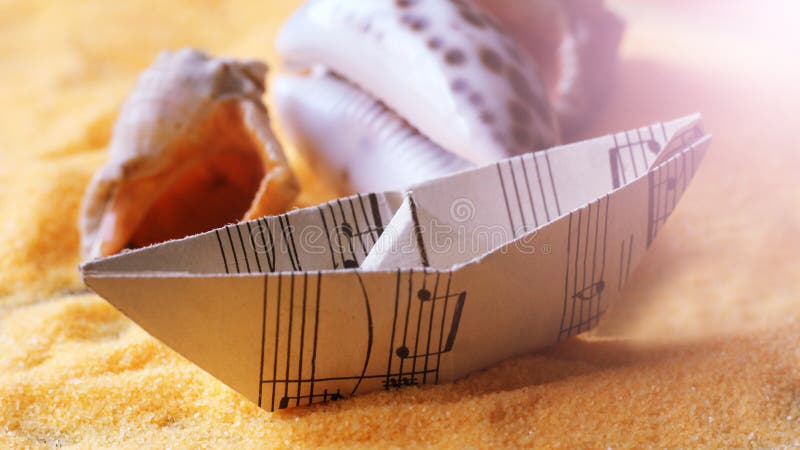 Model of a Ship Made of Paper Musical Notes on the Sand Stock Photo ...