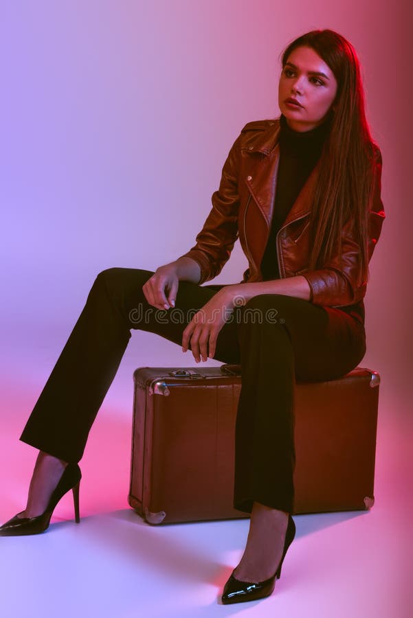 Model sitting on suitcase stock photo. Image of styling - 101471584