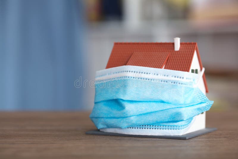 A Model of a Small House with a Mask Stock Photo - Image of small ...