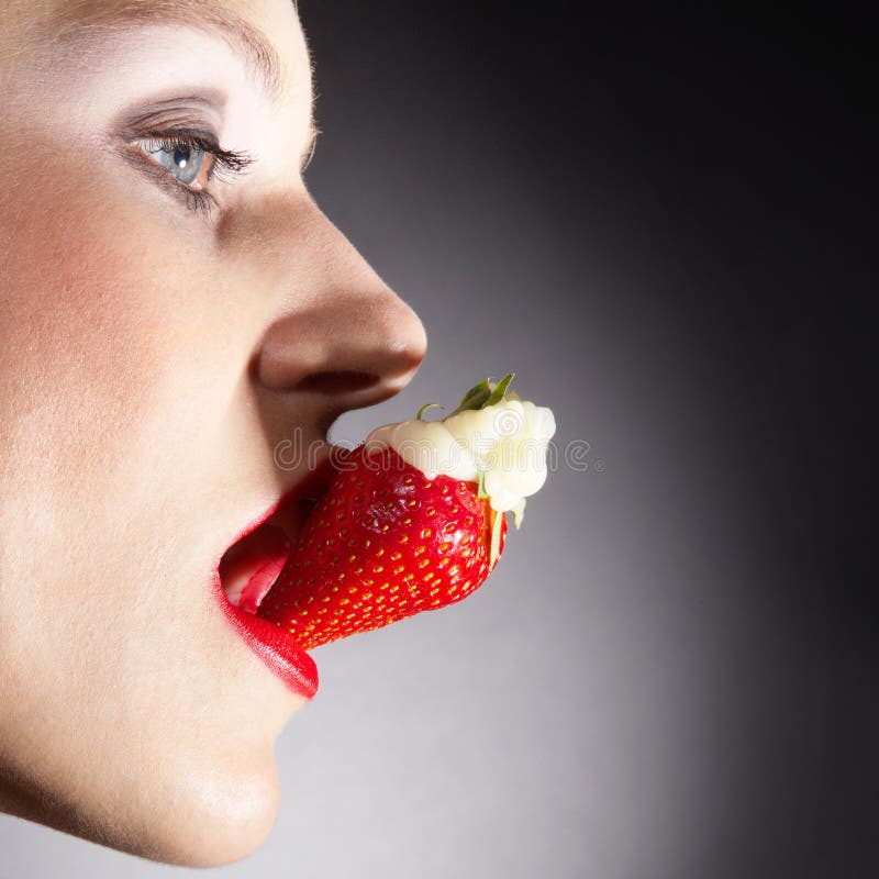 Beautiful Girl Tasting a Strawberry Stock Photo - Image of lipstick ...