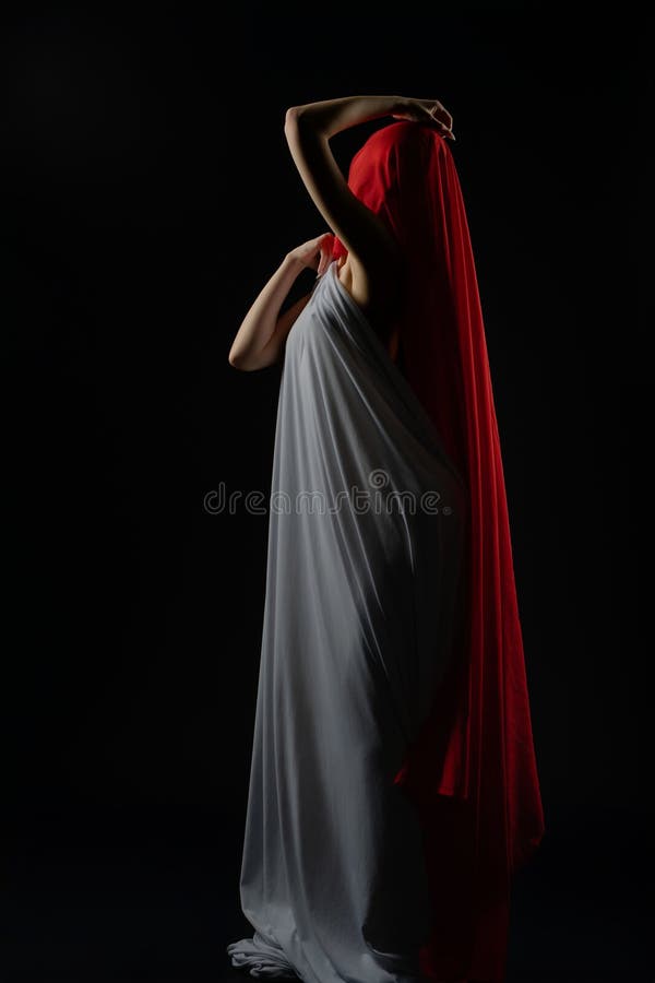 Model in Striking Red and White Attire Poses Dramatically Against Dark ...