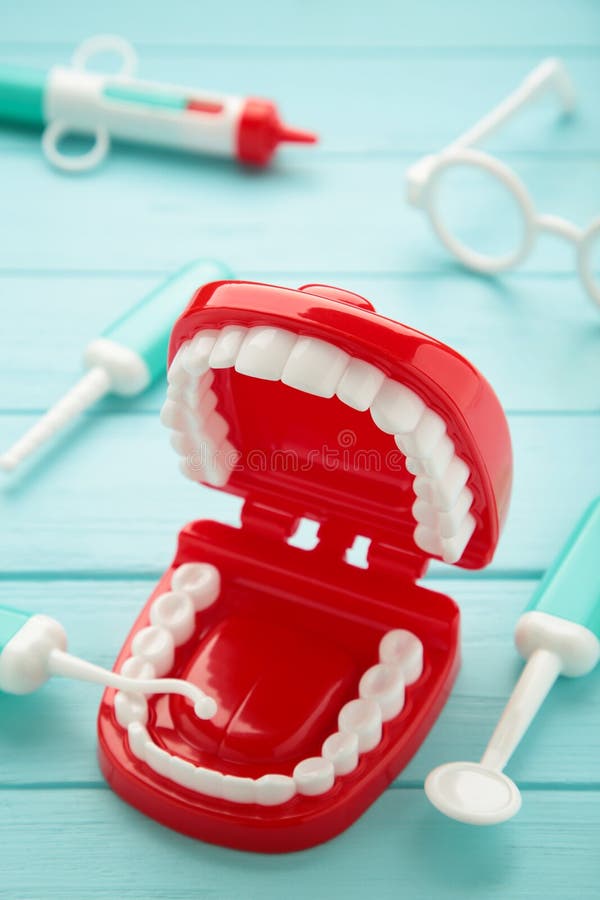 Model Toys Teeth with Dentist Instrument on Blue Background Stock Photo ...