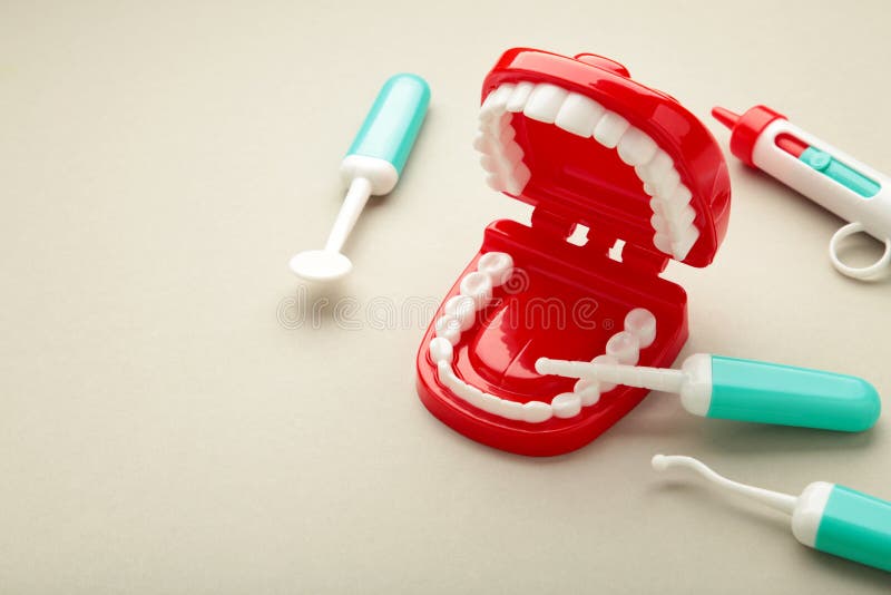 Model Toys Teeth with Dentist Instrument on Grey Background. Space for ...