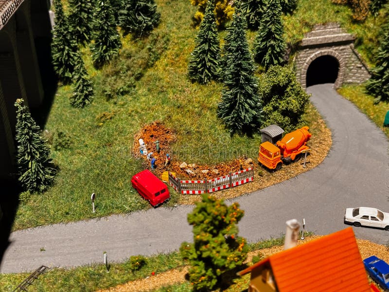 A Model Train Scene with a Red Car that Has Crashed into a Pile of ...