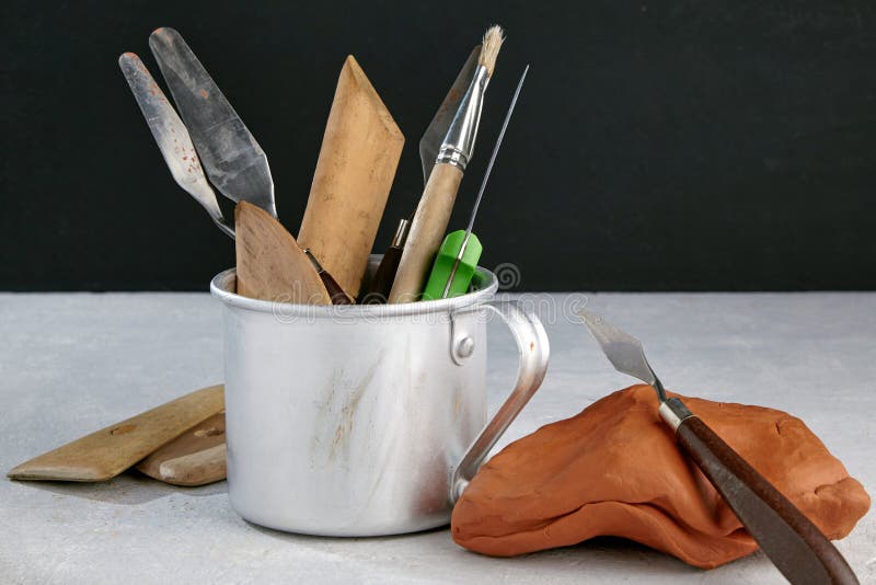 Modeling and Sculpting Stacks and a Piece of Clay on a Stone Table in a ...