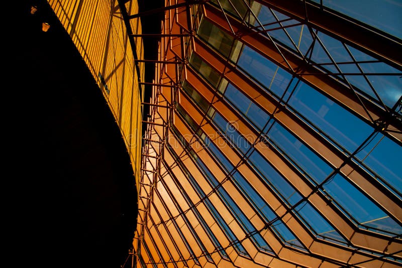 Modern Abstract Building with Colorful Metallic Columns Under a Blue ...