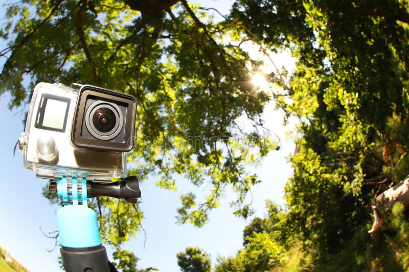 Modern Action Camera with Monopod Outdoors, Space for Text. Fisheye ...