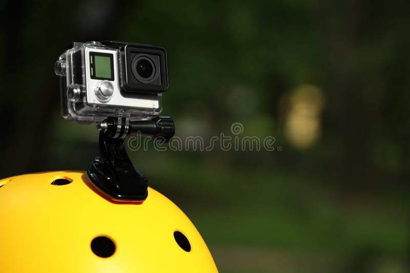 Modern Action Camera with Mount on Helmet Outdoors, Closeup. Space for ...