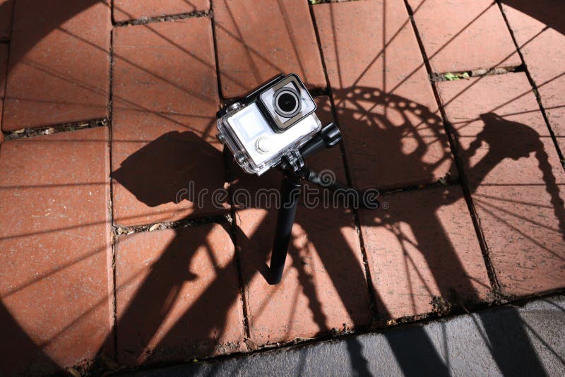 Modern Action Camera with Tripod on Pavement Outdoors, Above View Stock ...