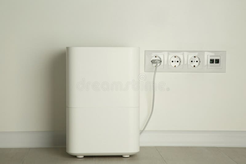 Modern Air Humidifier Plugged into Power Socket on Floor Indoors Stock ...