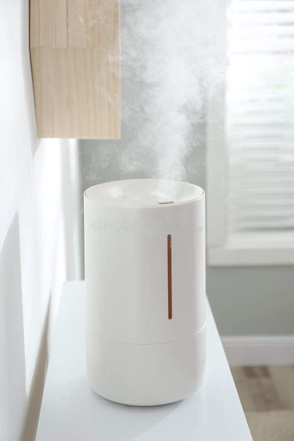 Modern Air Humidifier on Table at Home Stock Photo - Image of domestic ...