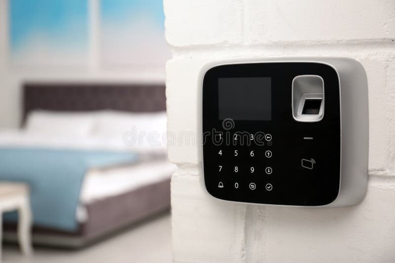 Modern Alarm System with Fingerprint Scanner on Brick Wall in House ...