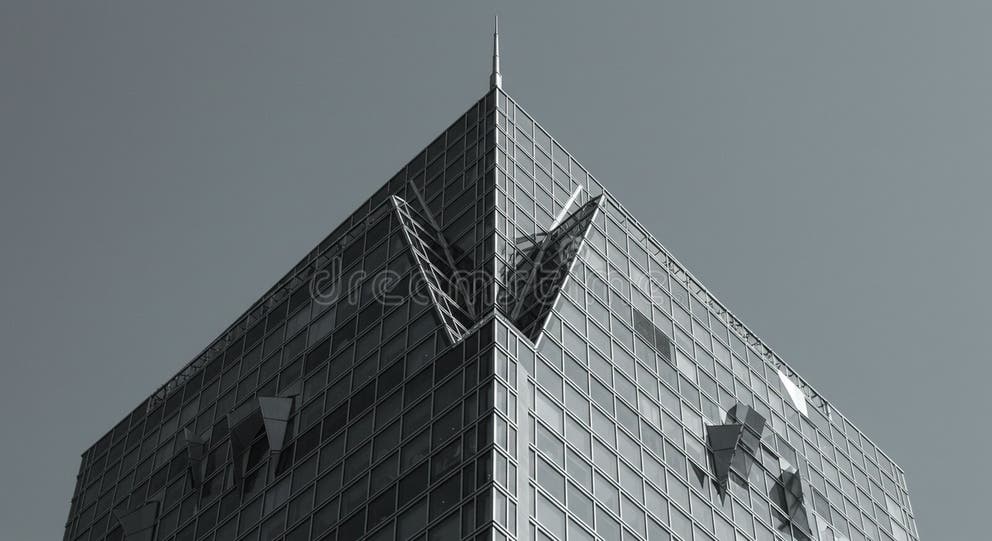 A Modern, Angular Skyscraper Dominated by a Grid of Reflective Glass ...