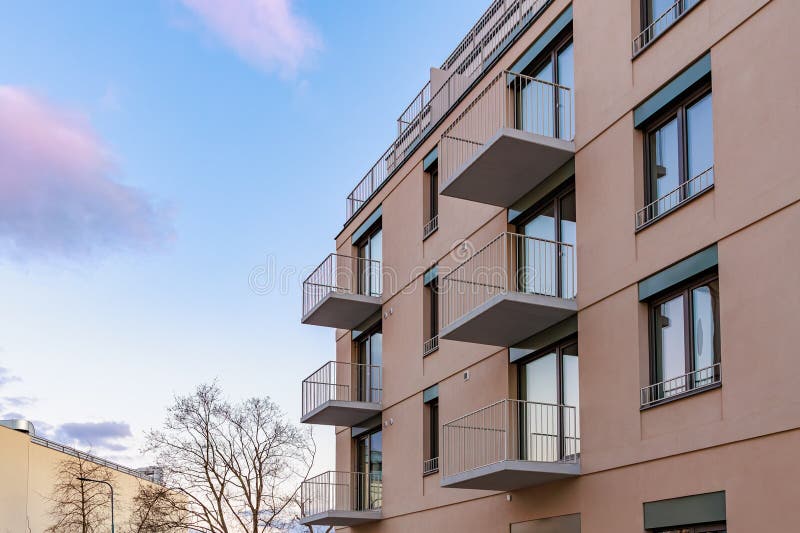 Modern Apartment Building Exterior with Balconies and Large Windows at ...