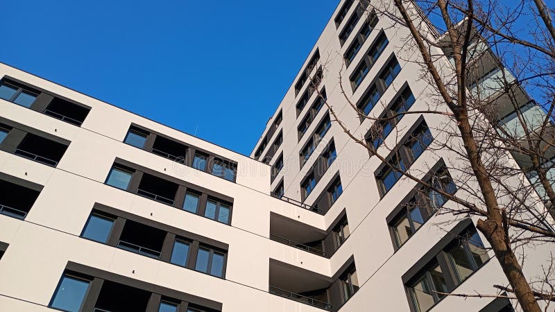 A Modern Apartment Building Stands Tall with a Sharp, White Facade and ...