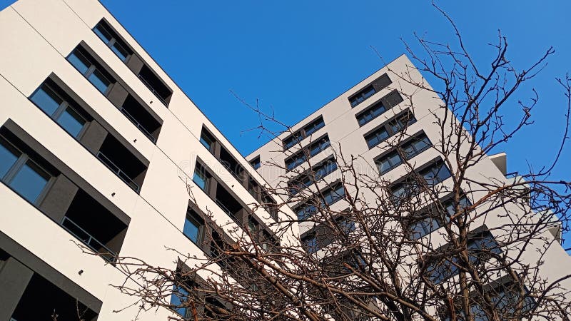 A Modern Apartment Building Stands Tall with a Sharp, White Facade and ...