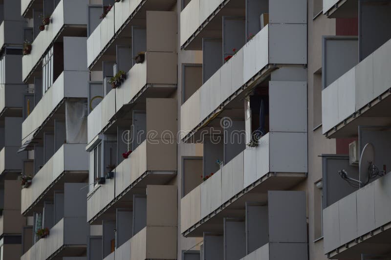 Modern Apartment Complex with Large Windows, Terraces and Planters ...