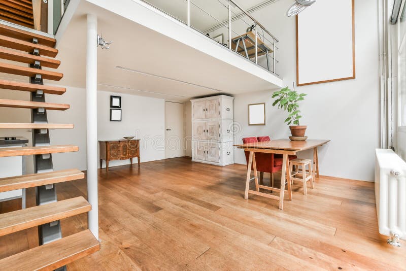 Modern Apartment Interior with a Dining Space and a Stairway To the ...