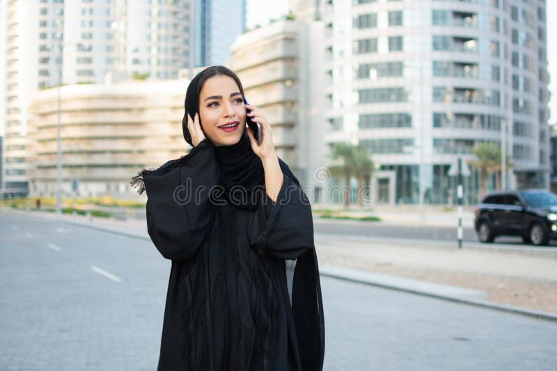 Modern Arabian Girl Using Mobile Phone on the Street. Stock Photo ...