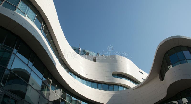 A Modern Architectural Building with Flowing, Undulating Forms and a ...