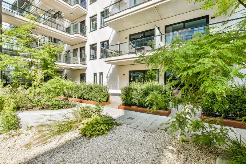 Modern Architectural Complex with Lush Greenery Stock Photo - Image of ...