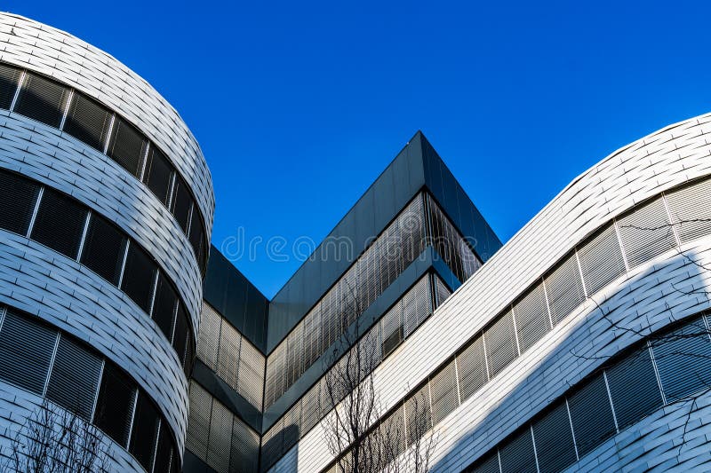 Modern Architectural Design with Curved and Angular Facades Against a ...