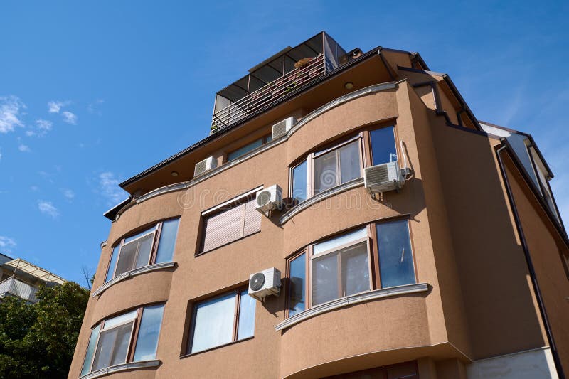 Modern Architectural Design of a Multi-story Building Showcasing Curved ...