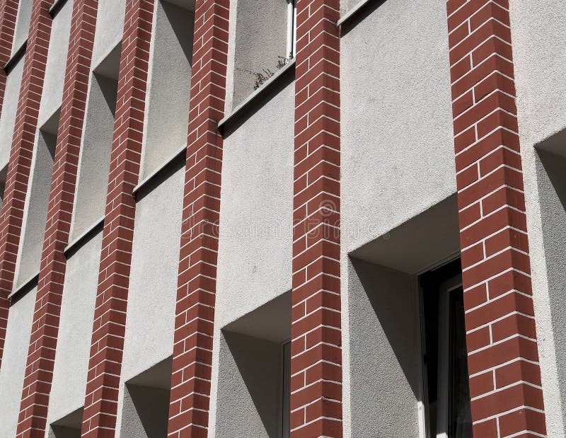 Modern Architectural Facade Featuring Red Brick and Gray Concrete Walls ...