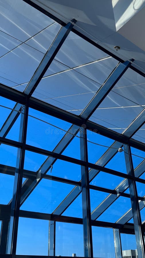 Modern Architectural Glass Roof with Blue Sky Backdrop Creating a ...