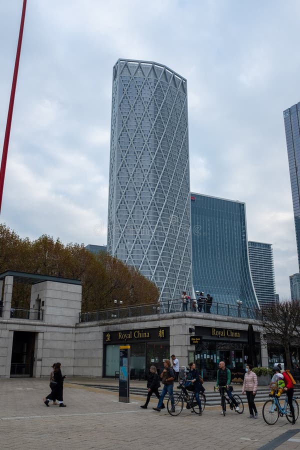 A Modern Architectural Scene Featuring a Tall, Cylindrical Skyscraper ...