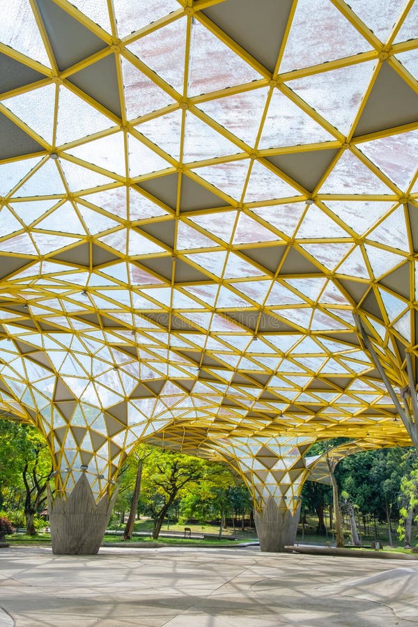 Modern Architectural Structure with Yellow Geometric Roof and Large ...