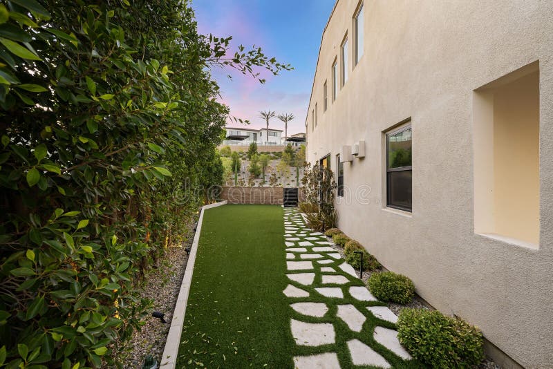 Modern Backyard with Artificial Grass and Stone Path at Sunset. Stock ...