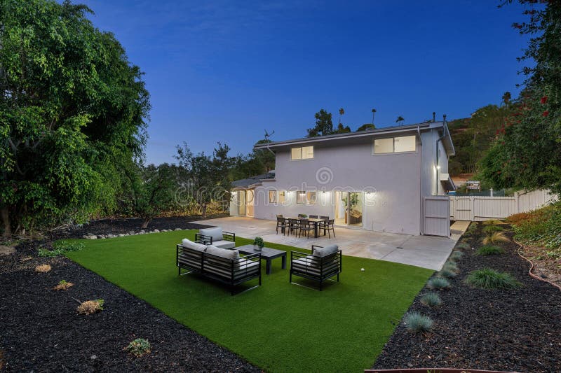 Modern Backyard with Outdoor Seating at Twilight. Stock Image - Image ...
