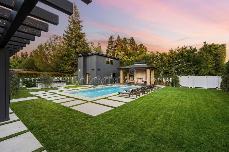 Modern Backyard with Pool and Lounge Chairs at Sunset Stock Image ...