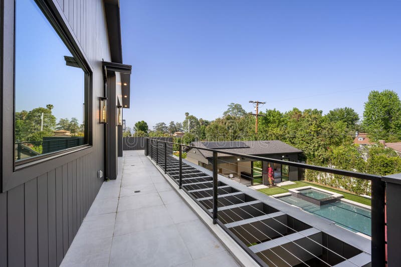 Modern Balcony with a Pool View and Greenery. Stock Photo - Image of ...