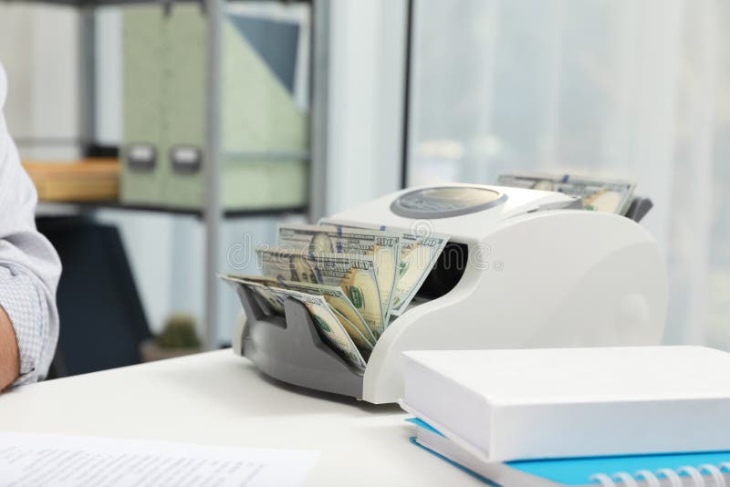 Modern Banknote Counter with Money on White Table Indoors Stock Photo ...