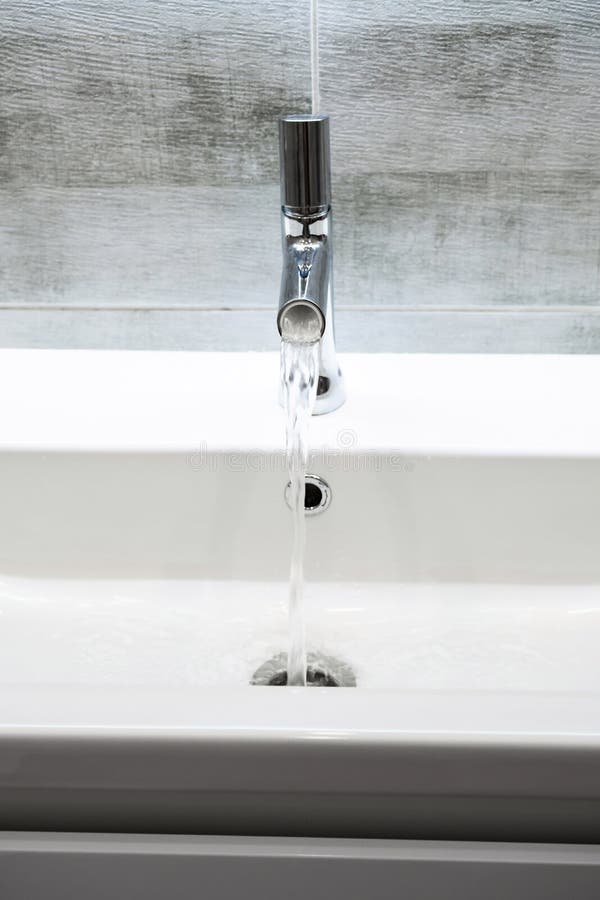 Modern Bathroom Faucet Flowing Water From Water Tap Copy Space Stock