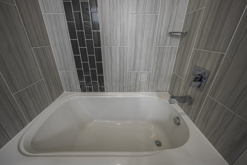 Modern Bathtub with Grey Backsplash Stock Image - Image of ceramic, fixture: 230694419