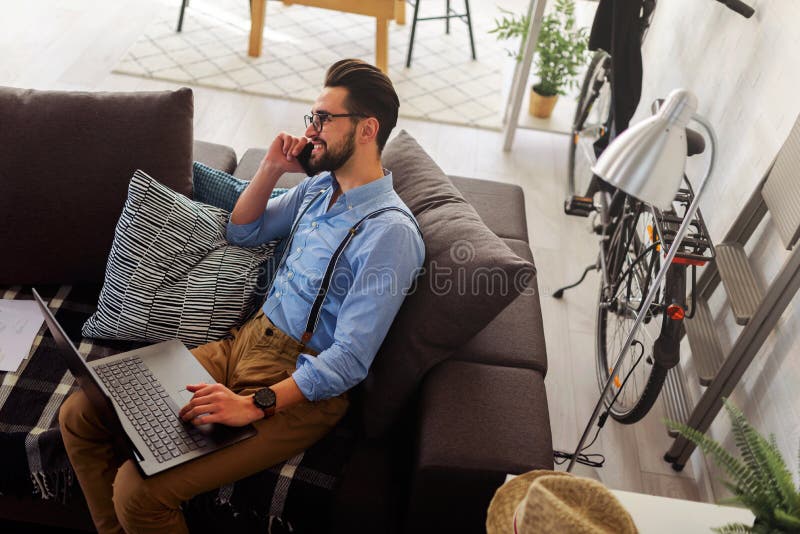 Young Businessman Working on Laptop Computer while Sitting on Sofa at ...