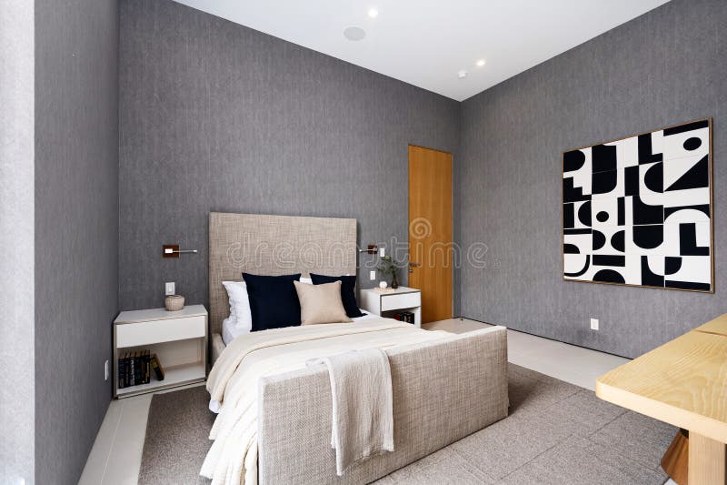 Modern Bedroom Featuring a Spacious Bed and Wall Art Editorial Stock ...