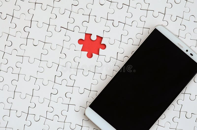 A Modern Big Smartphone with a Touch Screen Lies on a White Puzzle ...